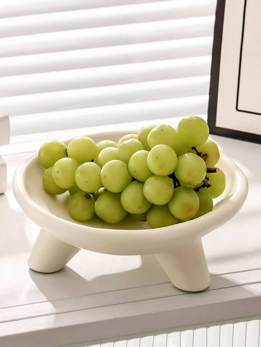 A Three-Legged Ceramic Round Fruit Plate With Creamy Style, Perfect For ...