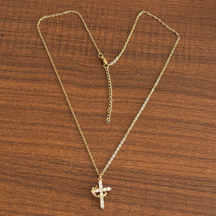 A Stainless Steel Cross Pendant Necklace And A Movable Golden Crown ...