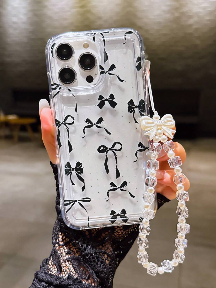 ブラックの水玉模様のリボンデザイン、耐衝撃スマホケース、ファッショナブルなストラップ付き。Apple 17 Pro Max、11、12、13 ...